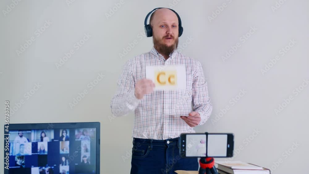 Online English training. A bald man with a beard gives a lesson using ...