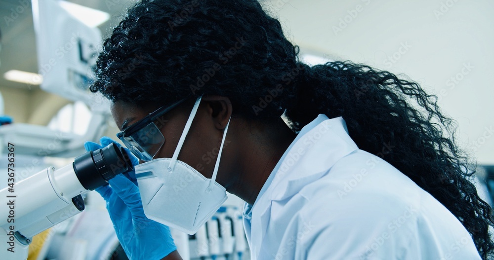 African American scientist working in labs on AIDS cure. Chemical ...