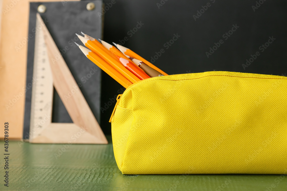 Pencil case and stationery on dark background Stock Photo | Adobe Stock