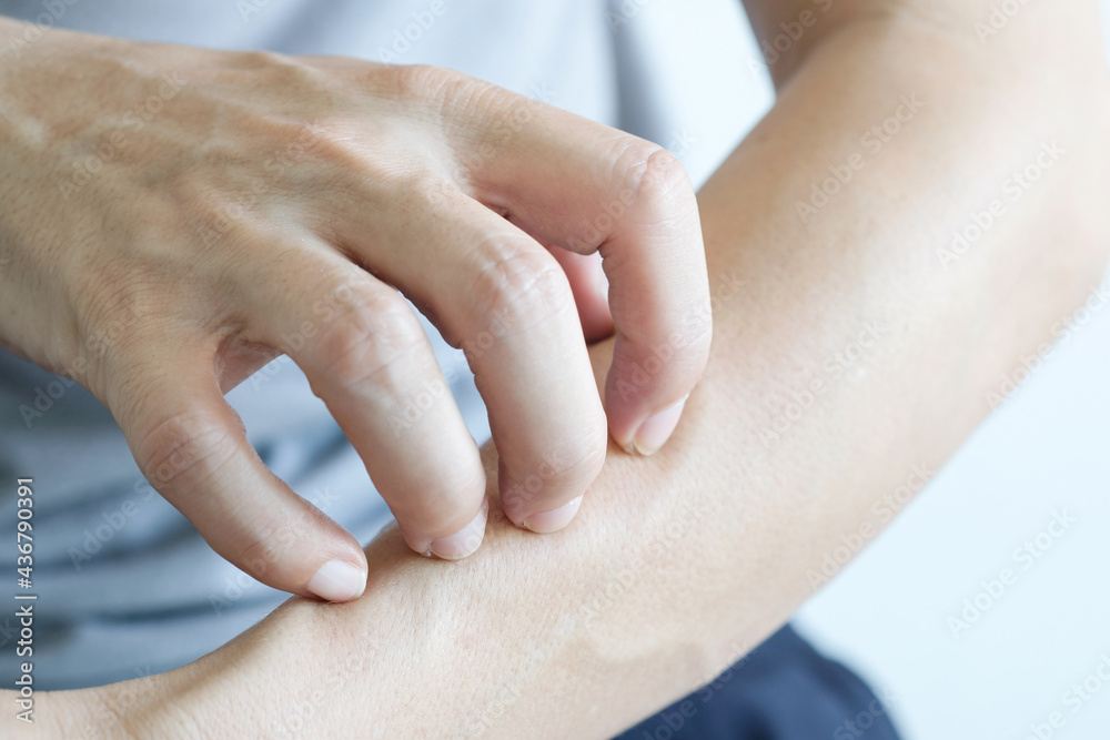 The man's hands he uses his hands to scratch his back because of ...