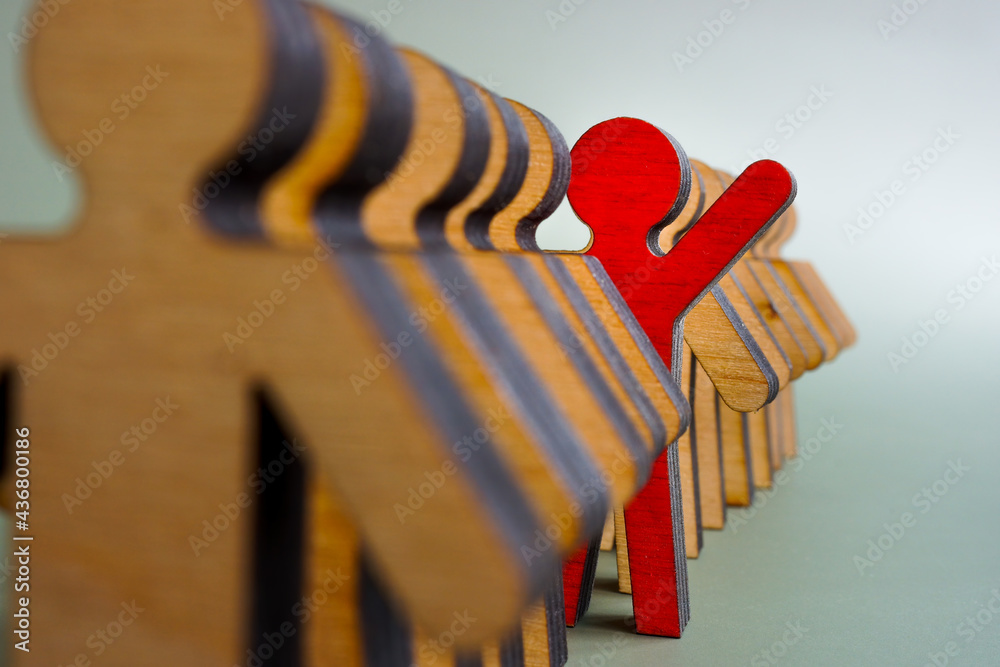 Activist stand out from the crowd concept. The red figurine is in the ...