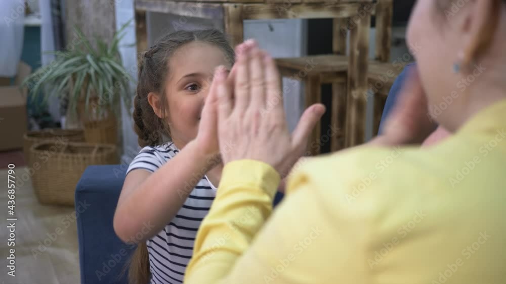Happy family. Mom and daughter clap their hands. Lockdown coronavirus ...