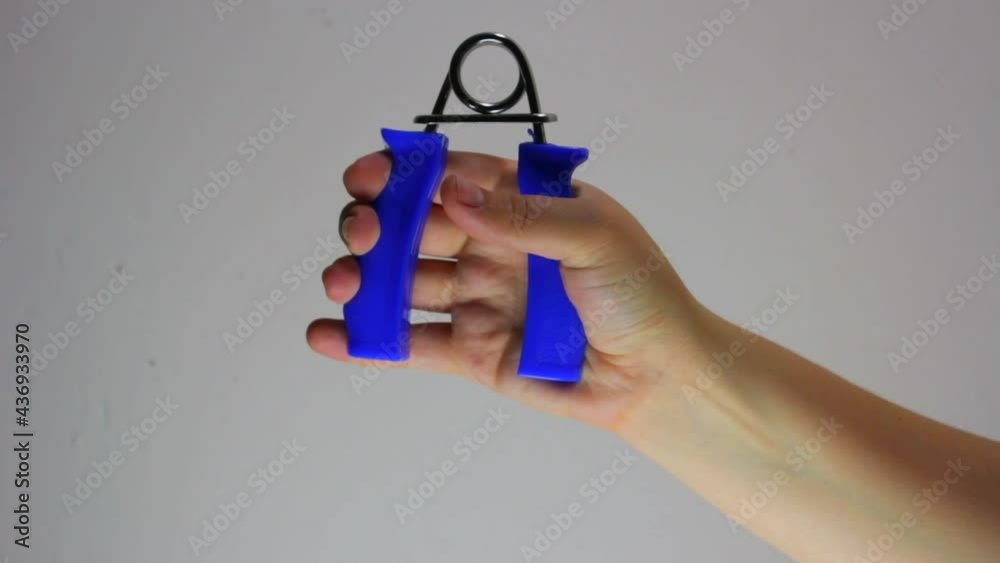 Exercising a wrist with a hand gripper as a physiotherapy after cast ...