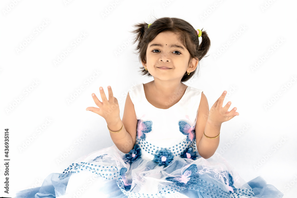 Cheerful Indian / Asian kid with shrug gesture asking something and ...