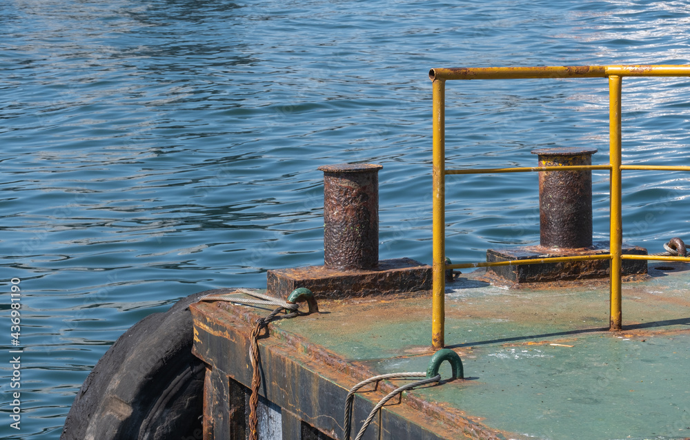 old and rusted bollard, worn and dirty concrete floor, ferry dock, old ...