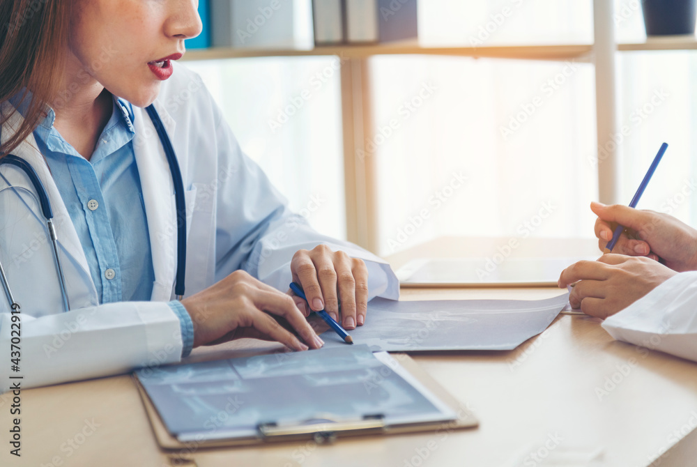 Two asian women doctors discuss meeting doctor's office medical clinic ...