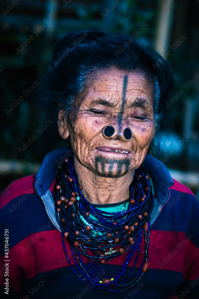 apatani tribal women facial expression with her traditional nose lobes ...