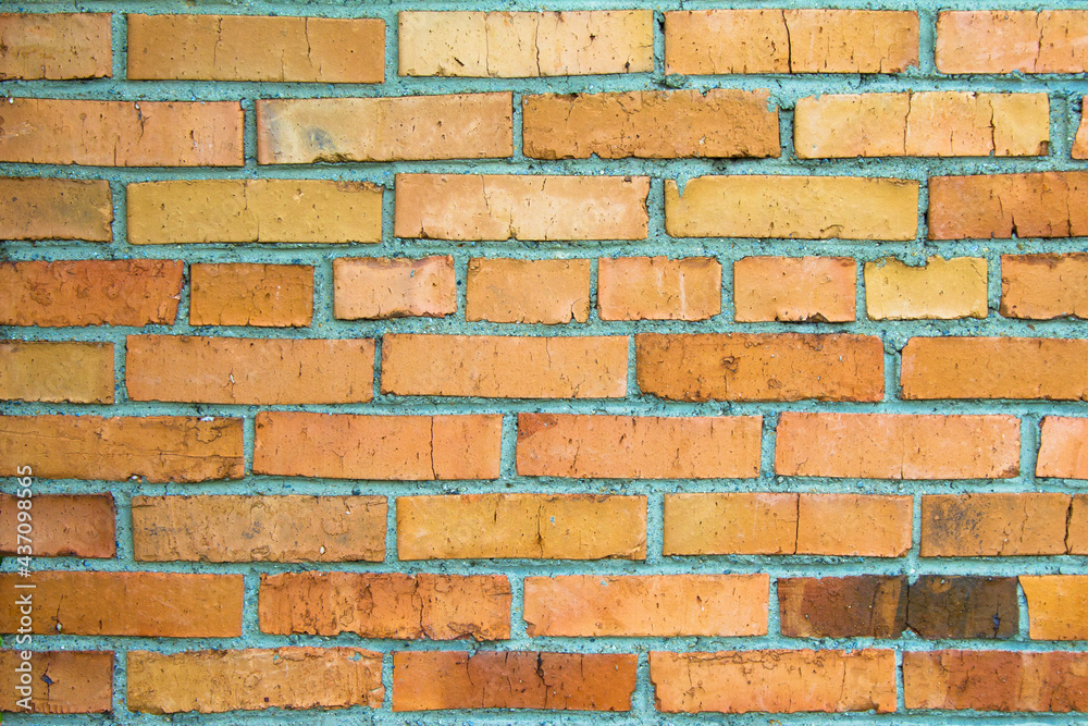 Frontal view of a wall made of red old bricks of different sizes and ...