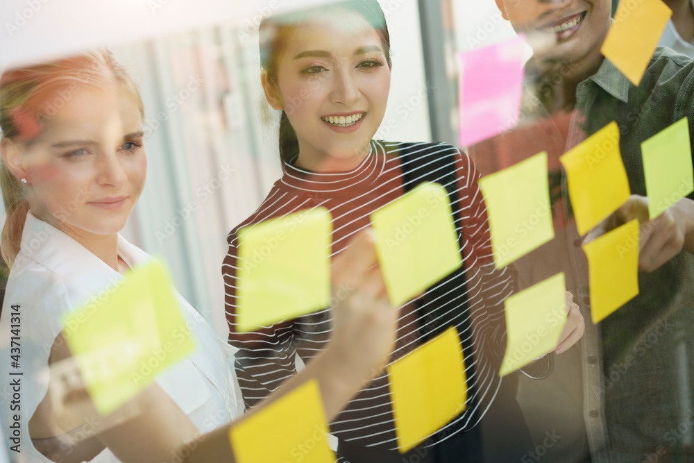 Business people meeting at office and use post it notes to share idea ...