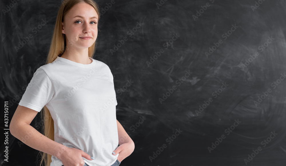 Portrait of a tall smiling female student standing in front of a ...