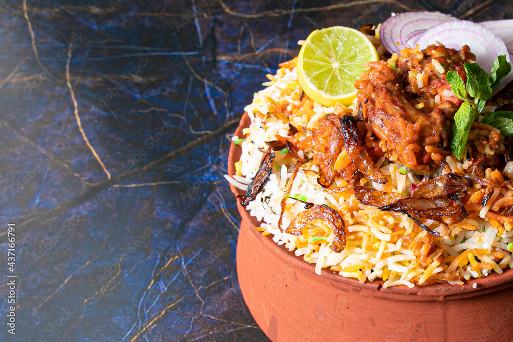 Top shot of Paneer Rice Biryani in Mud Pot garnished with lemon and ...