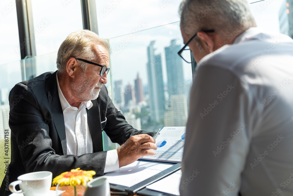 Two business men discussing idea in the office. One man is explaining ...