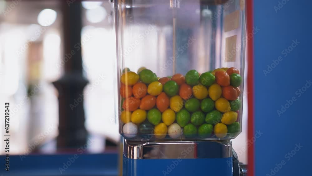 Gumball vending machine with plastic container full of candies ...