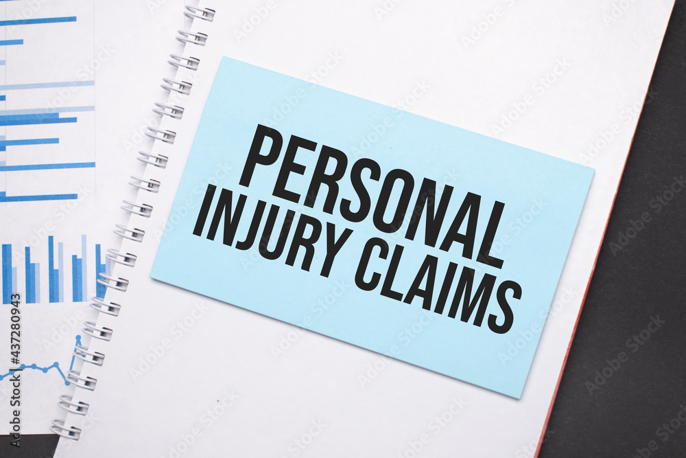 Paper plate with text Personal injury claims. Diagram, notepad and blue ...