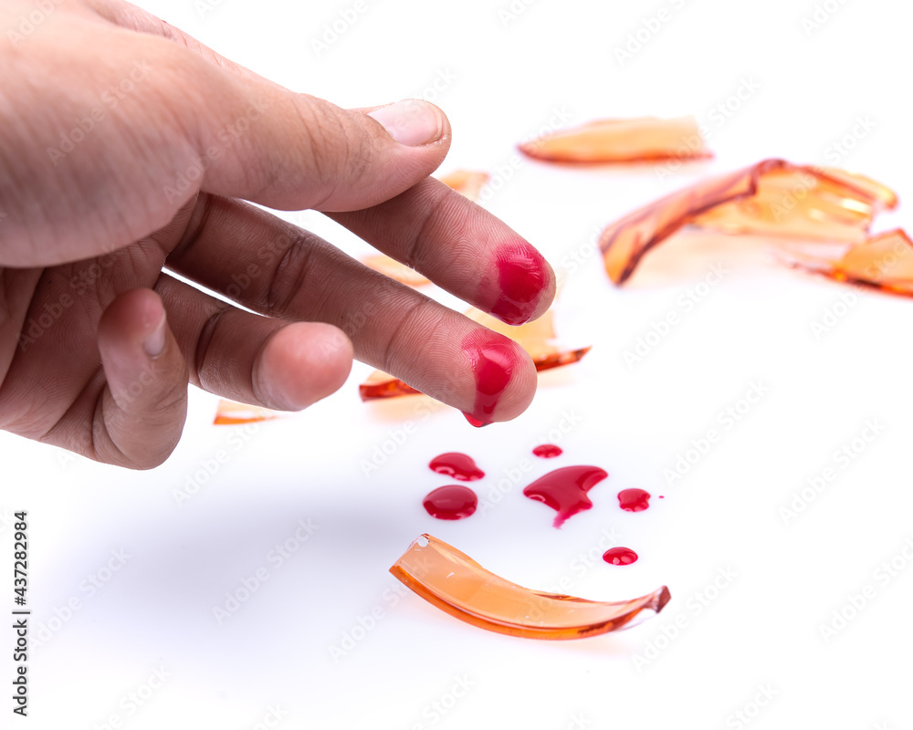 Broken glass cut a middle finger got some blood on white background ...