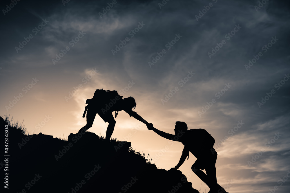 Mountain combiners helping each other climb up a mountain edge. Giving ...
