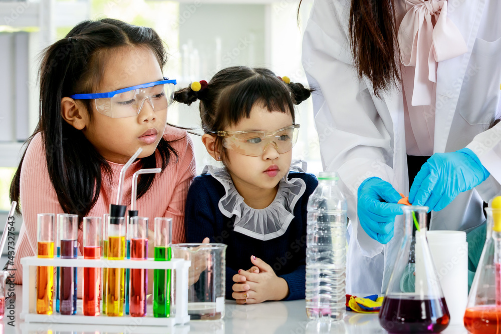 Asian female professional scientist teacher in white lab coat rubber ...