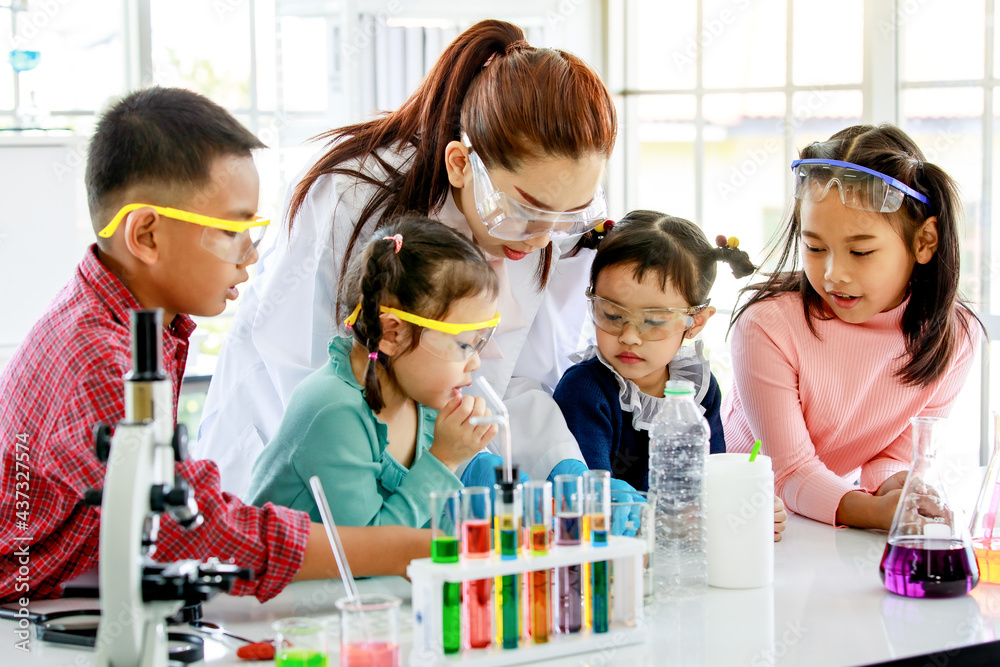 Asian female professional scientist teacher in white lab coat rubber ...
