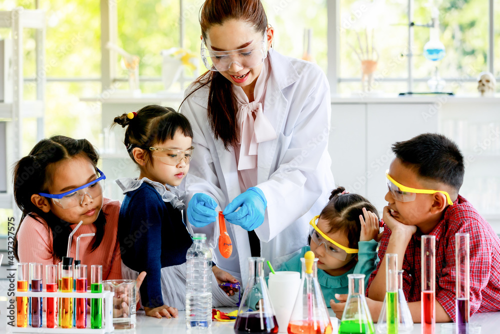 Asian female professional scientist teacher in white lab coat rubber ...