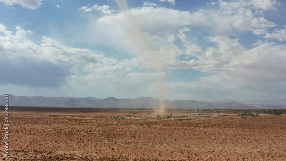A sandstorm or dust devil with spinning wind send a dust cloud in the ...