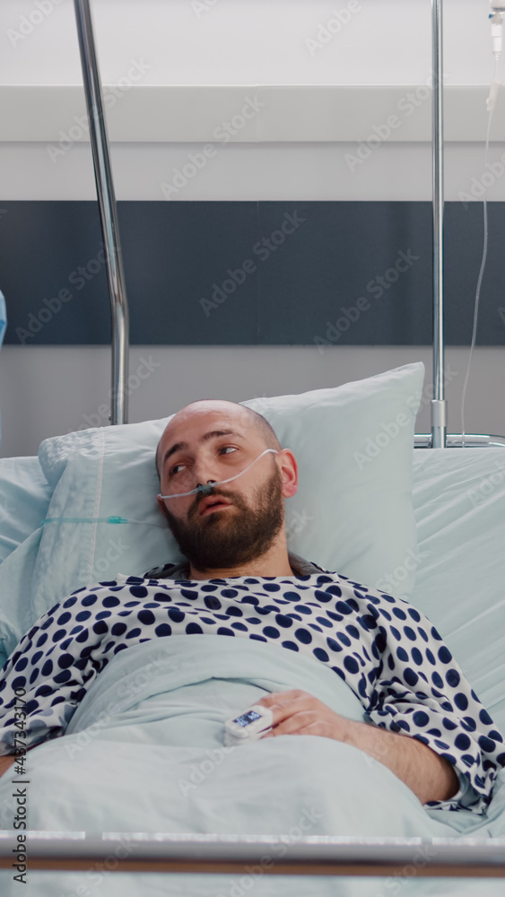 Practitioner nurse monitoring patient during sickness recovery writing ...