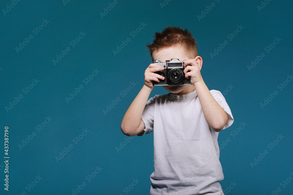 Little boy taking a picture using a retro camera. Child boy with ...