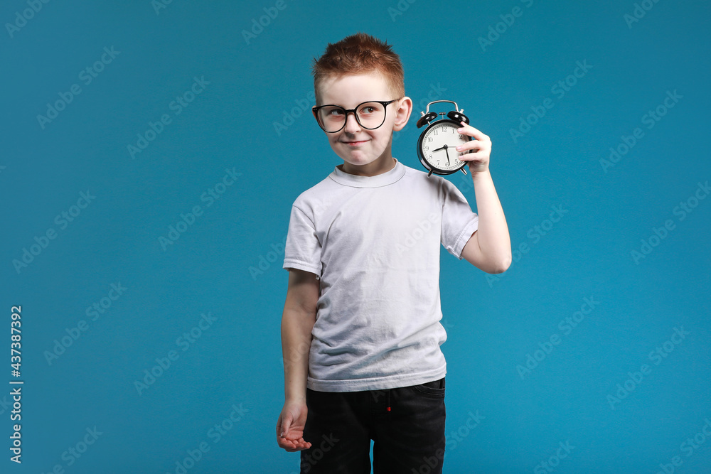 Time management. Morning. little boy with alarm clock. Happy childhood ...