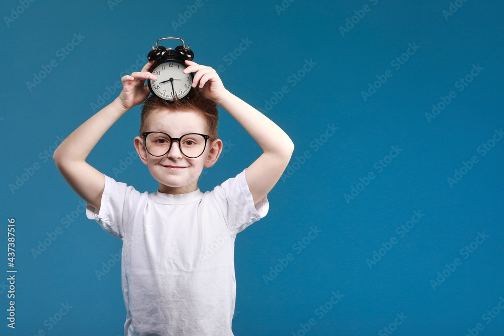 Time management. Morning. little boy with alarm clock. Happy childhood ...