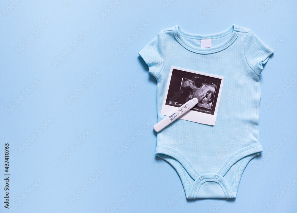 Clothes for the newborn, a positive pregnancy test and an ultrasound ...