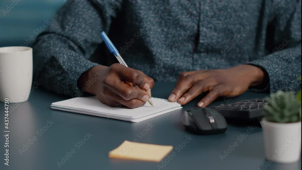 Closeup african american black man hands taking notes on notepad using ...