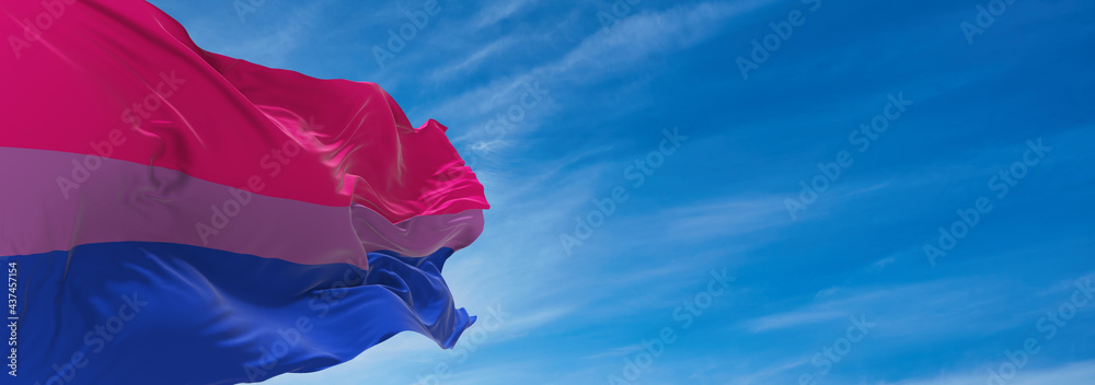 Bisexual Pride flag waving in the wind at cloudy sky. Freedom and love ...