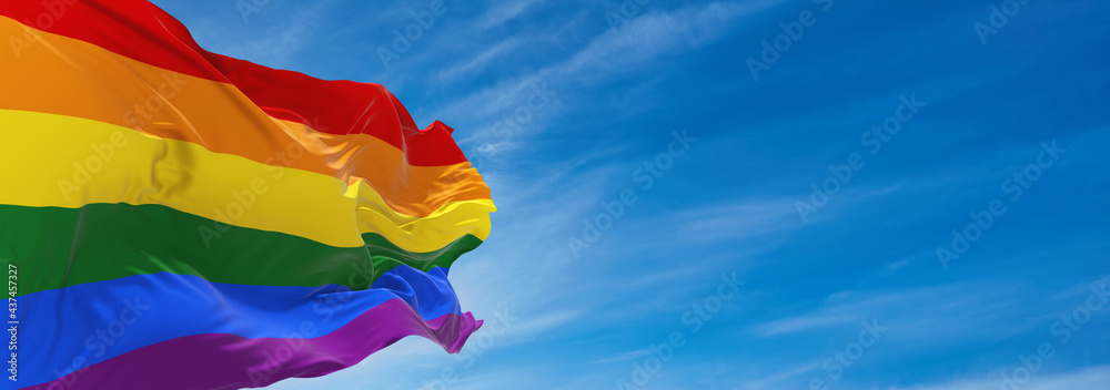 Gay Pride flag waving in the wind at cloudy sky. Freedom and love ...