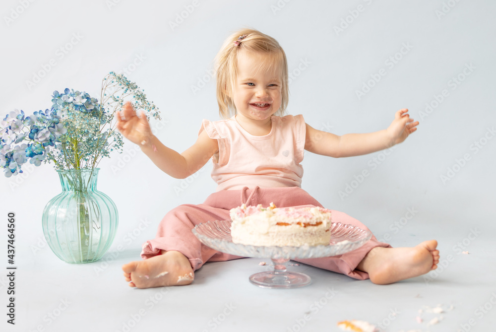 motion blur portrait of little beautiful blue-eyed girl celebrates her ...