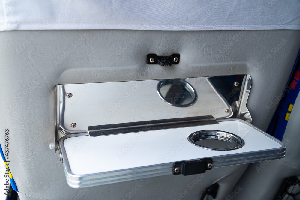 Hinged trays for food and beverages. Car drink holder stuck on back of ...