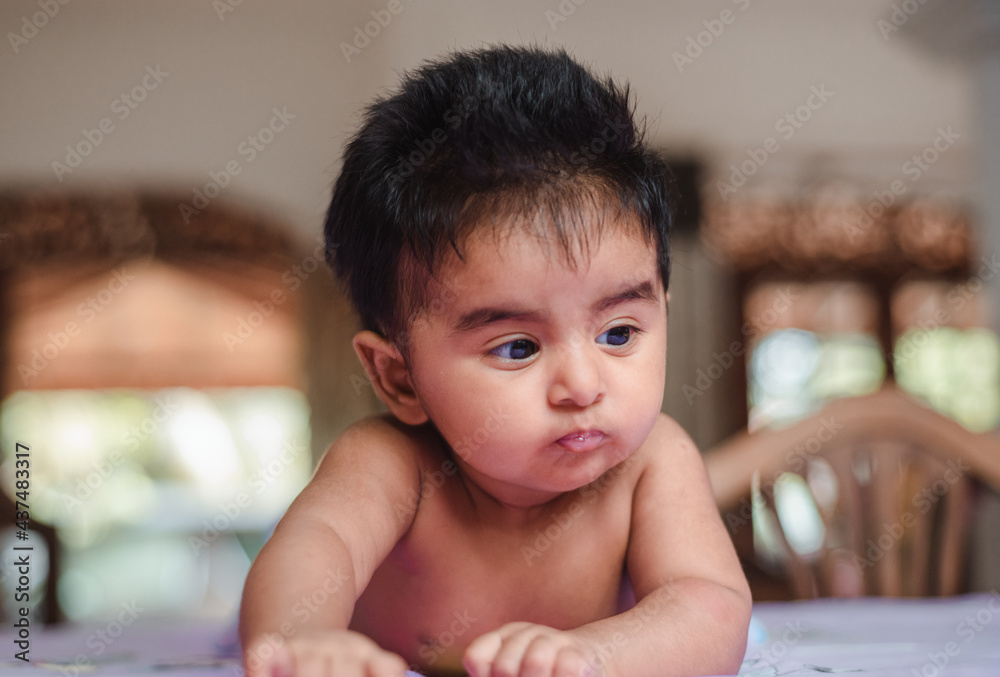 Baby photoshoot in 4-month celebration. Cute baby girl facing the ...