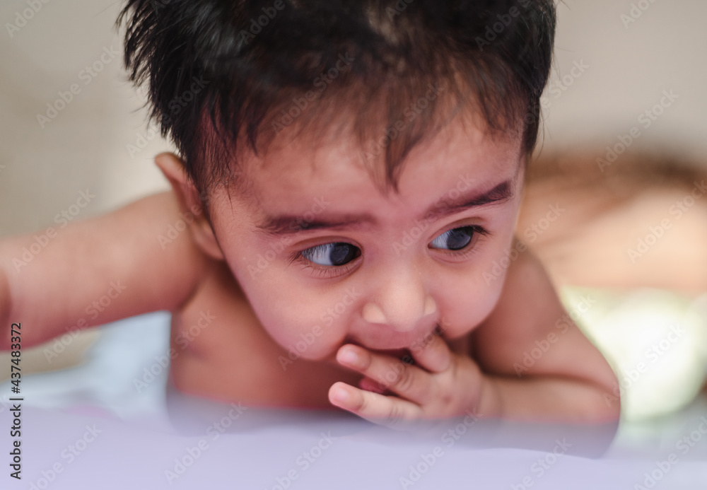 4 months old baby keeps a hand in the mouth, chewing her own fingers ...