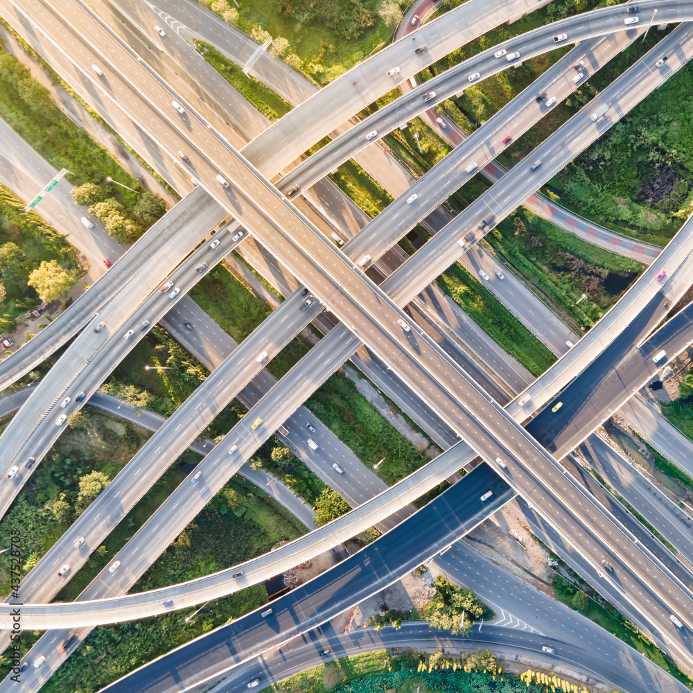 Aerial view of road interchange or highway intersection with busy urban ...