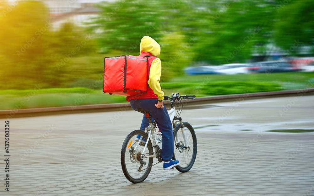 Delivery service courier on bike deliever food in rainy weather. Food ...