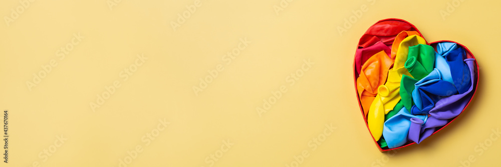Heart shaped rainbow lgbtq flag against yellow background, pride month ...