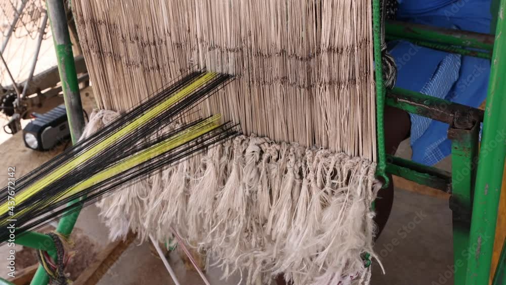 Manual loom making kente material northern Ghana. Kente is worn by the ...