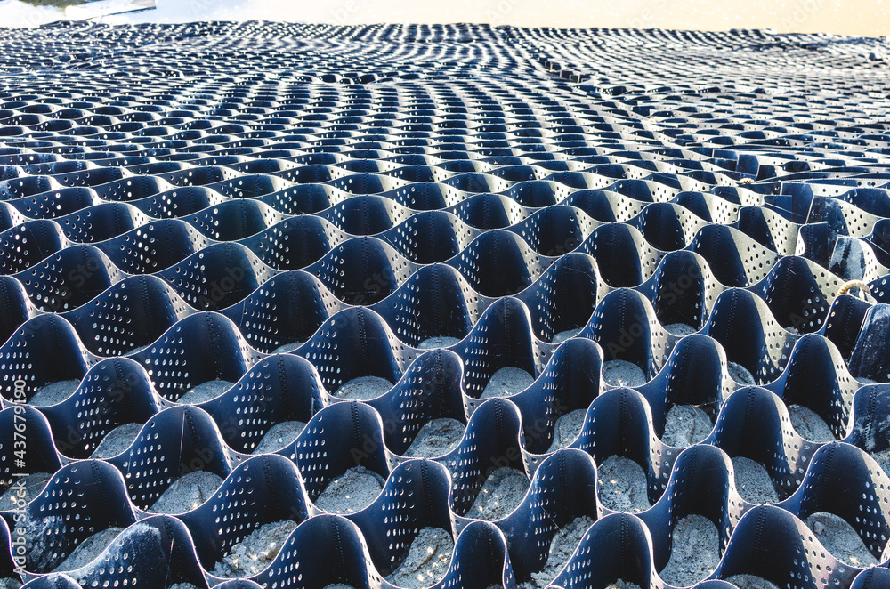 Polymer geogrid is not filled with soil. Strengthening the slope with a ...