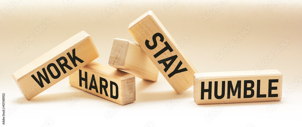 Work Hard, Stay Humble Text written on wooden blocks and white ...