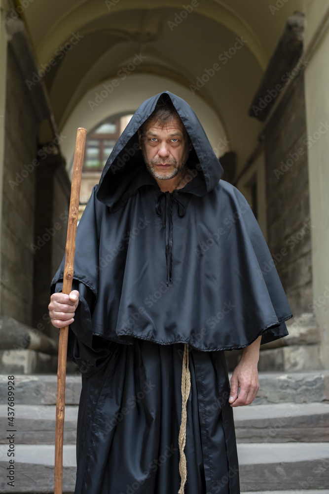 Portrait of an elderly monk 45-50 years old with a beard in a black ...