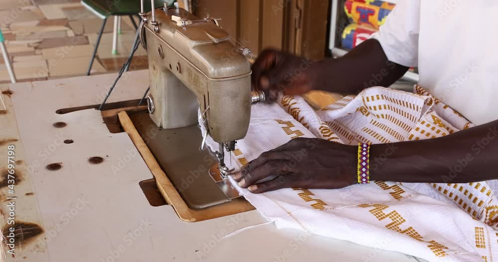 Sewing hand loom Kente strips cloth fabric Kumasi Ghana. Kente is worn ...