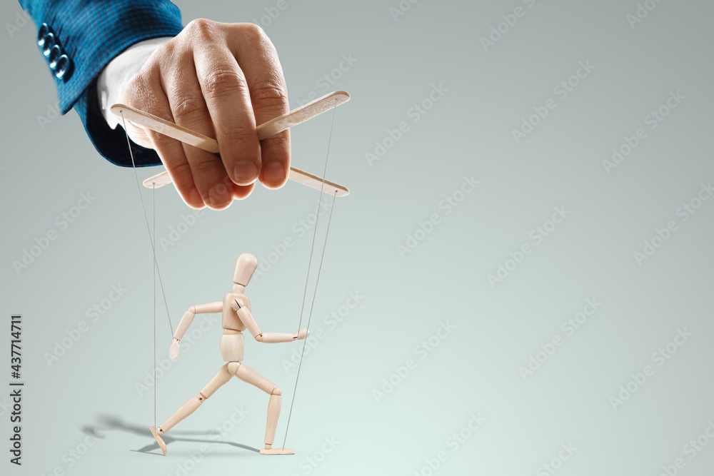 Foto de Male hand, puppeteer controls the puppet puppet with strings. A ...