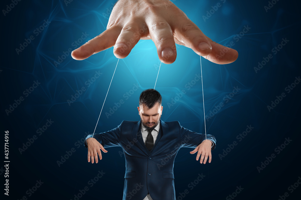 Male hand, puppeteer controls the puppet puppet with strings. A doll on ...