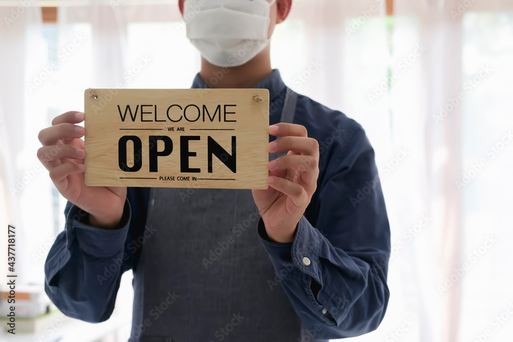Open. barista, Coffee shop owner with face mask turning open sign board ...