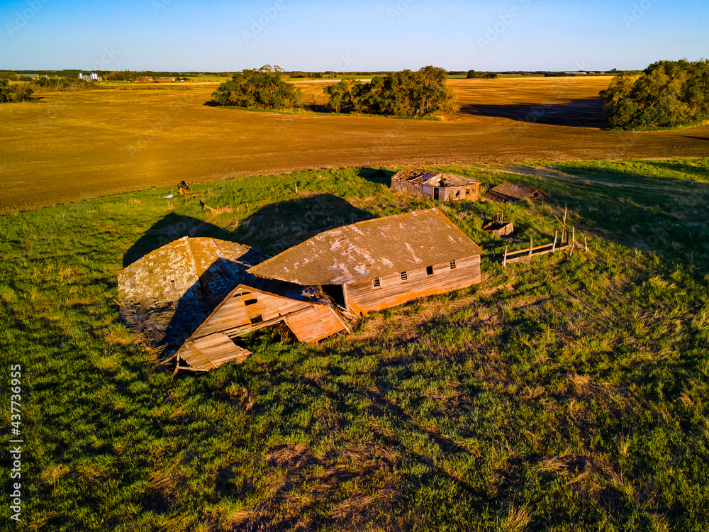 An aerial view of an old farm yard that has been abandoned, forgotten ...