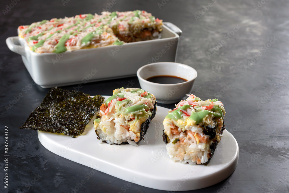 Baked sushi casserole. Rice, a layer of cream cheese, trout, seaweed ...
