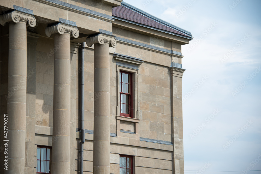 A wide brick entrance to a large courthouse, justice or government ...